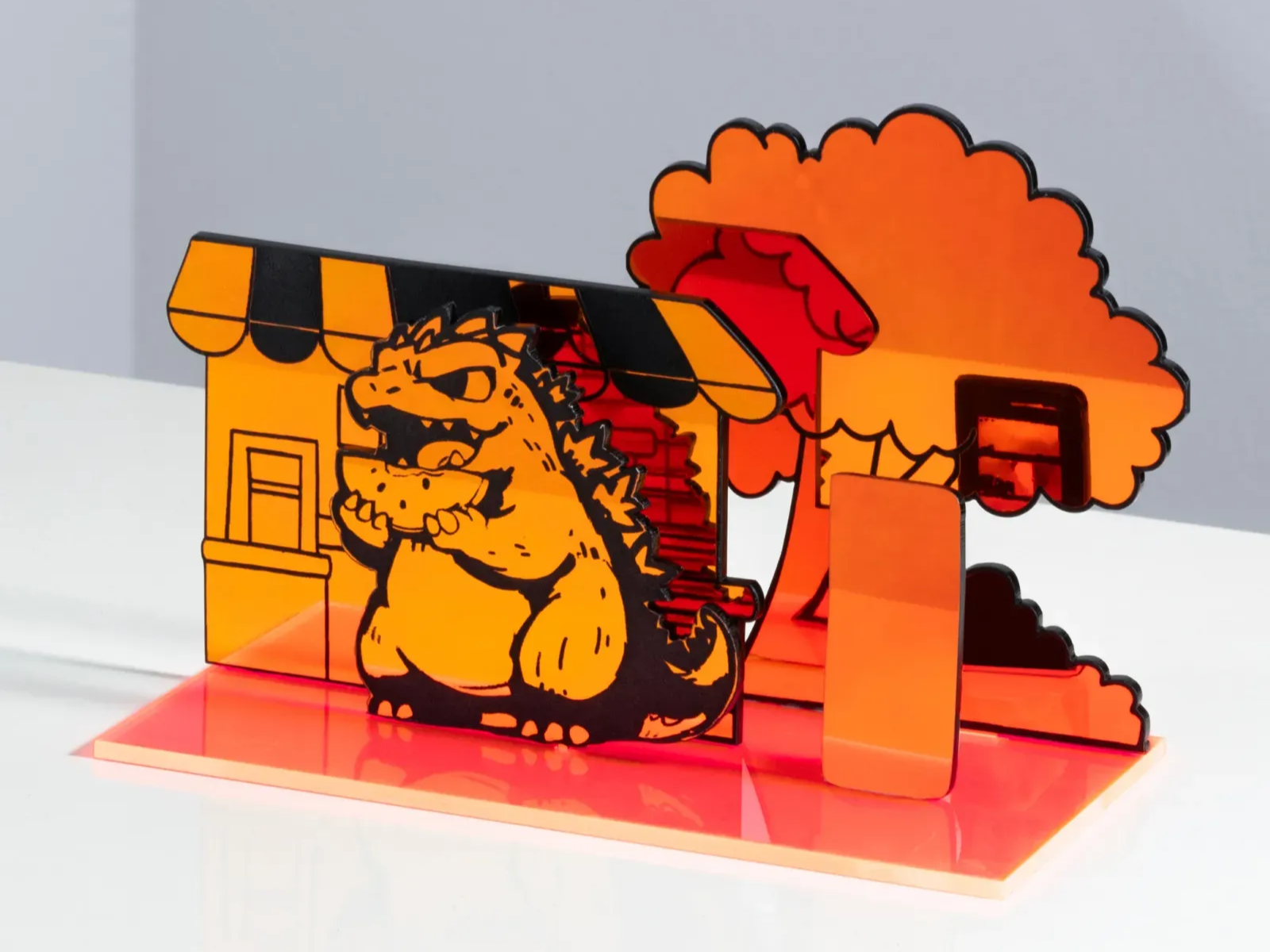 Laser-cut acrylic Godzilla tabletop decorations, with a fluorescent ...